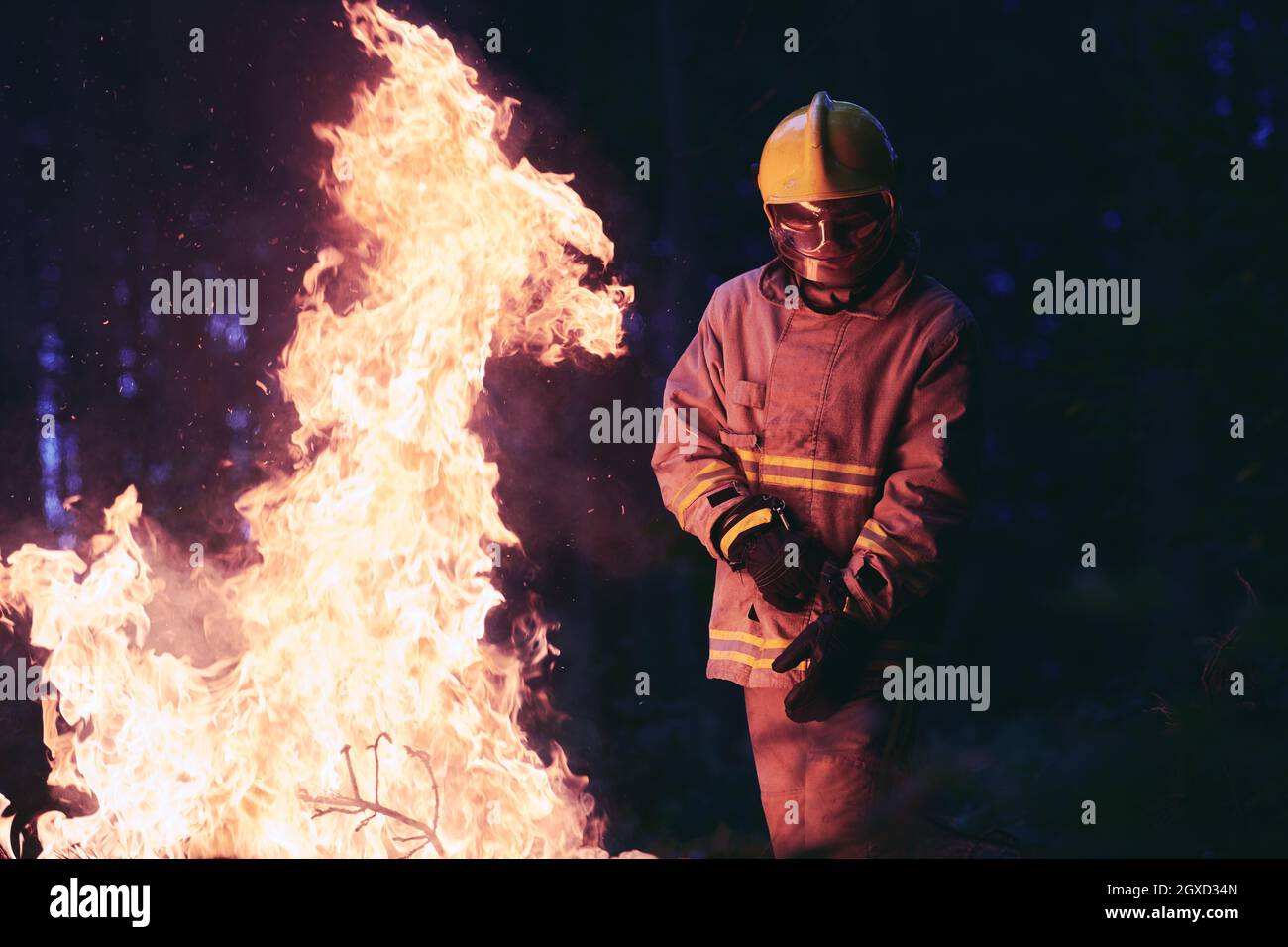 firefighter hero in action danger jumping over fire flame to rescue and ...