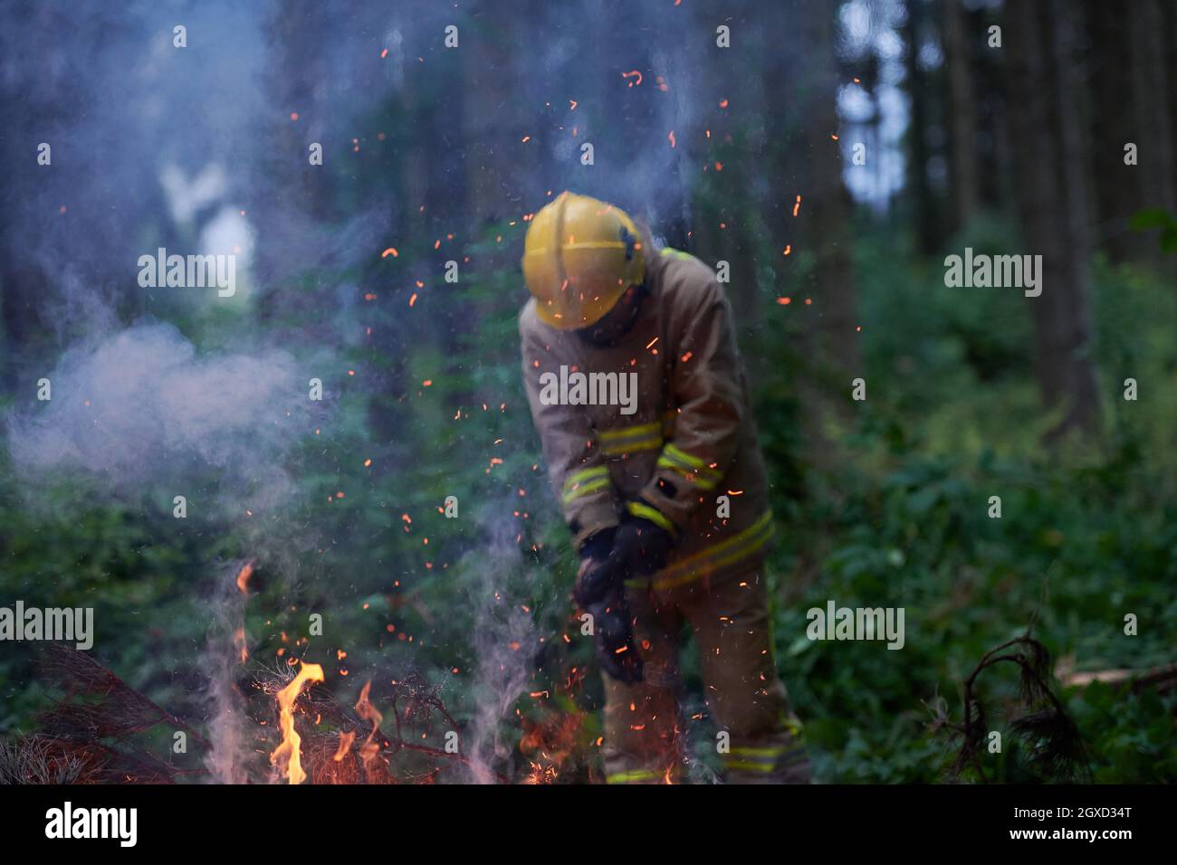 firefighter hero in action danger jumping over fire flame to rescue and ...