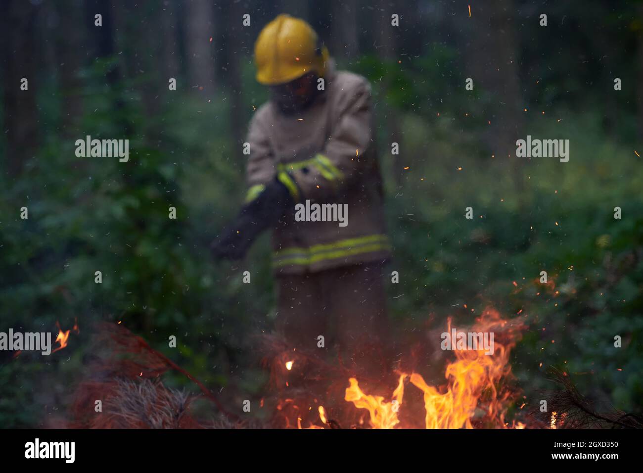 firefighter hero in action danger jumping over fire flame to rescue and ...