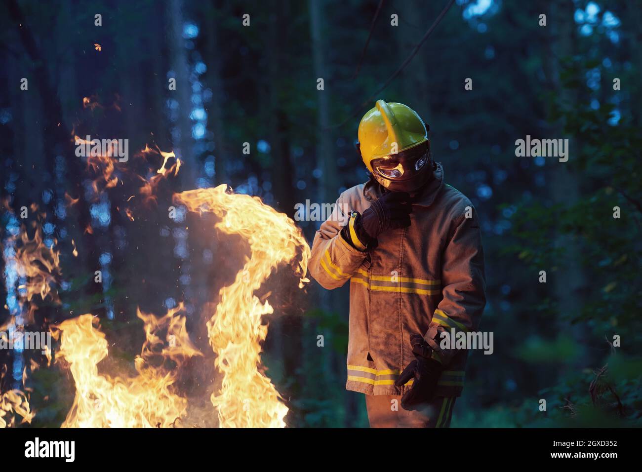 firefighter hero in action danger jumping over fire flame to rescue and ...