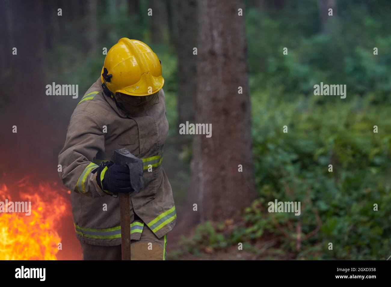 firefighter hero in action danger jumping over fire flame to rescue and ...