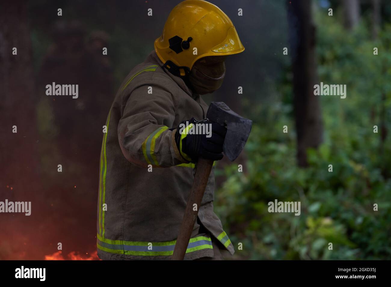 firefighter hero in action danger jumping over fire flame to rescue and ...