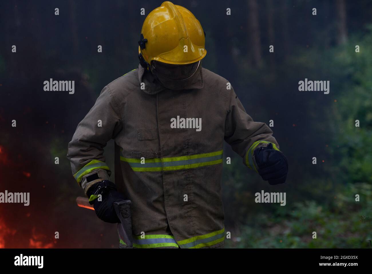 firefighter hero in action danger jumping over fire flame to rescue and ...
