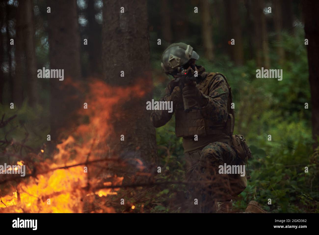 modern warfare soldier in action aiming at weapon laser sight optics in ...