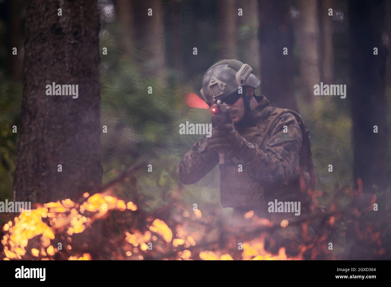modern warfare soldier in action aiming at weapon laser sight optics in ...