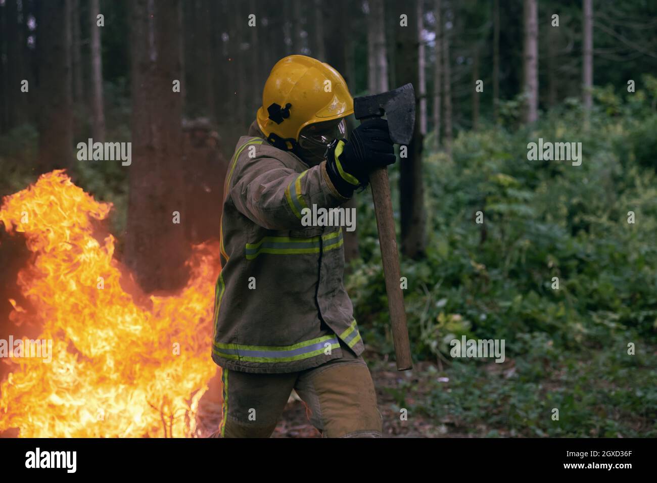 firefighter hero in action danger jumping over fire flame to rescue and ...