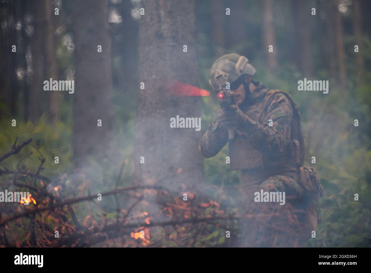 modern warfare soldier in action aiming at weapon laser sight optics in ...
