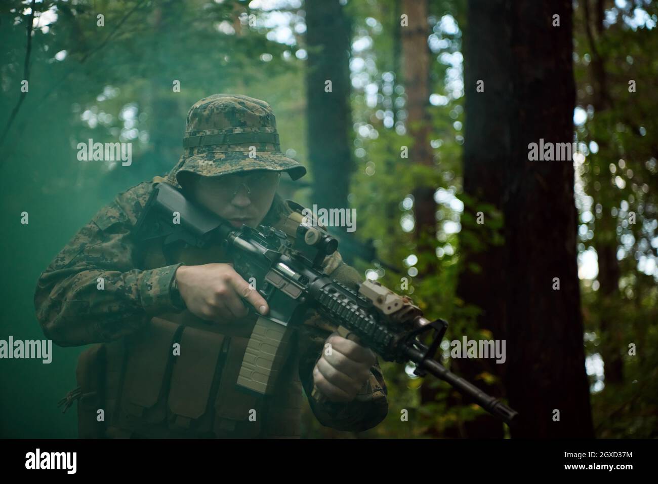 modern warfare soldier in action aiming at weapon laser sight optics in ...