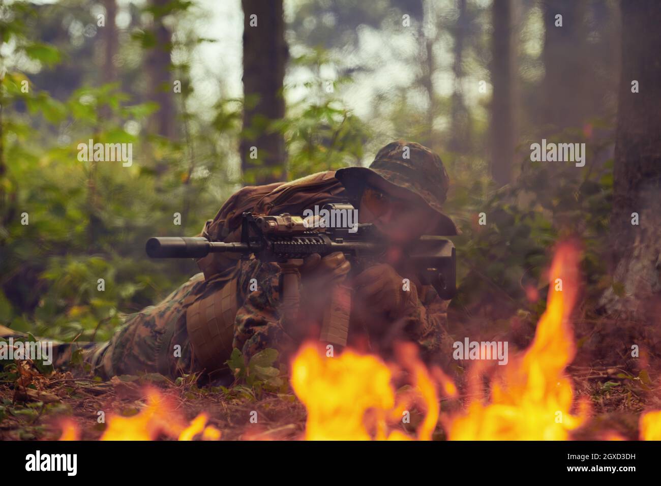 modern warfare soldier in action aiming at weapon laser sight optics in ...