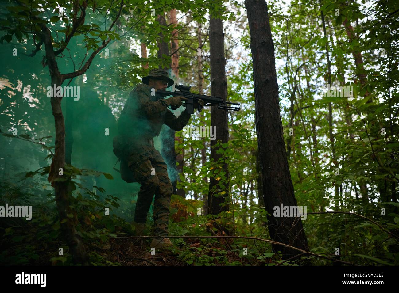 modern warfare soldier in action aiming at weapon laser sight optics in ...