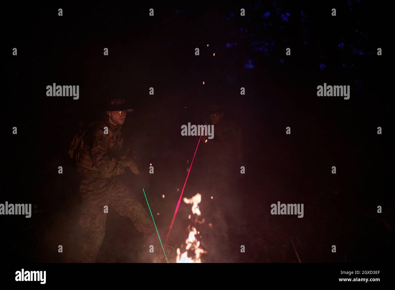 soldiers squad in action on night mission using laser sight beam lights ...