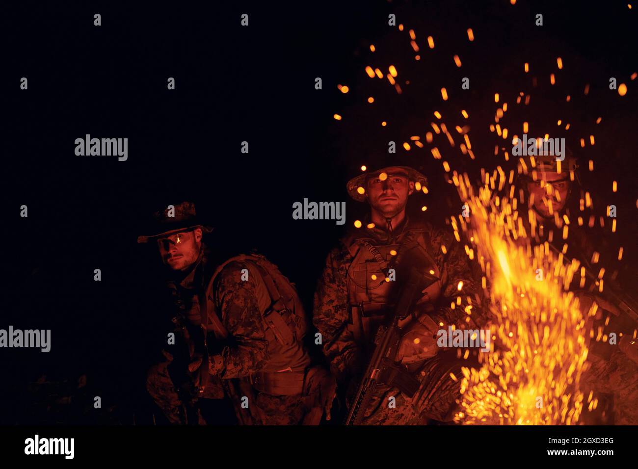 soldiers squad in action on night mission using laser sight beam lights ...