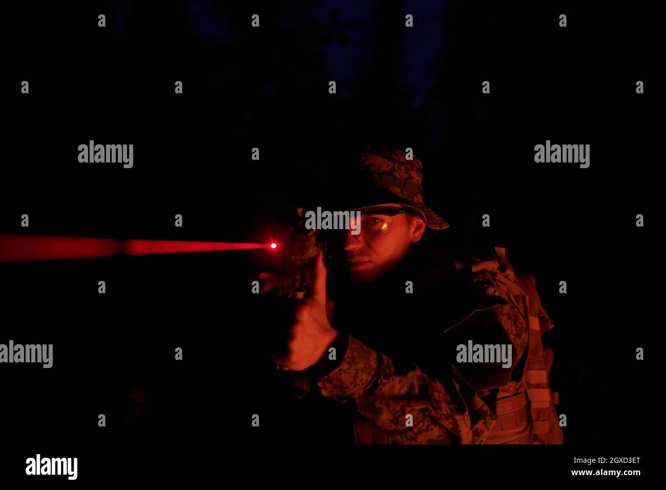 soldiers squad in action on night mission using laser sight beam lights ...
