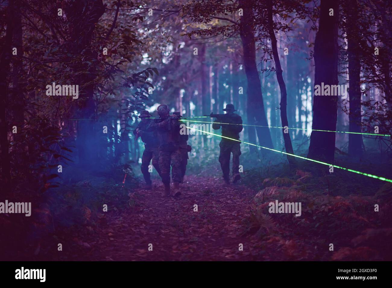 soldiers squad in action on night mission using laser sight beam lights ...