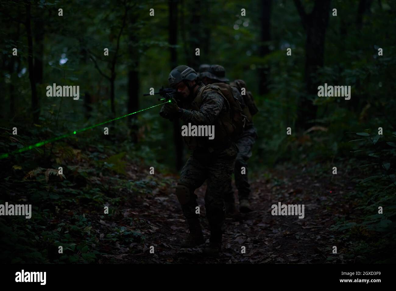 soldiers squad in action on night mission using laser sight beam lights ...