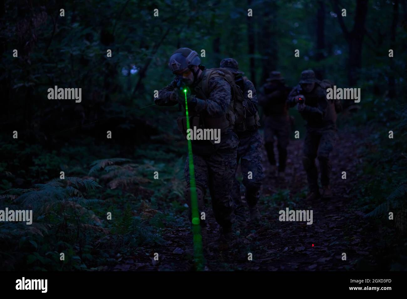 soldiers squad in action on night mission using laser sight beam lights ...