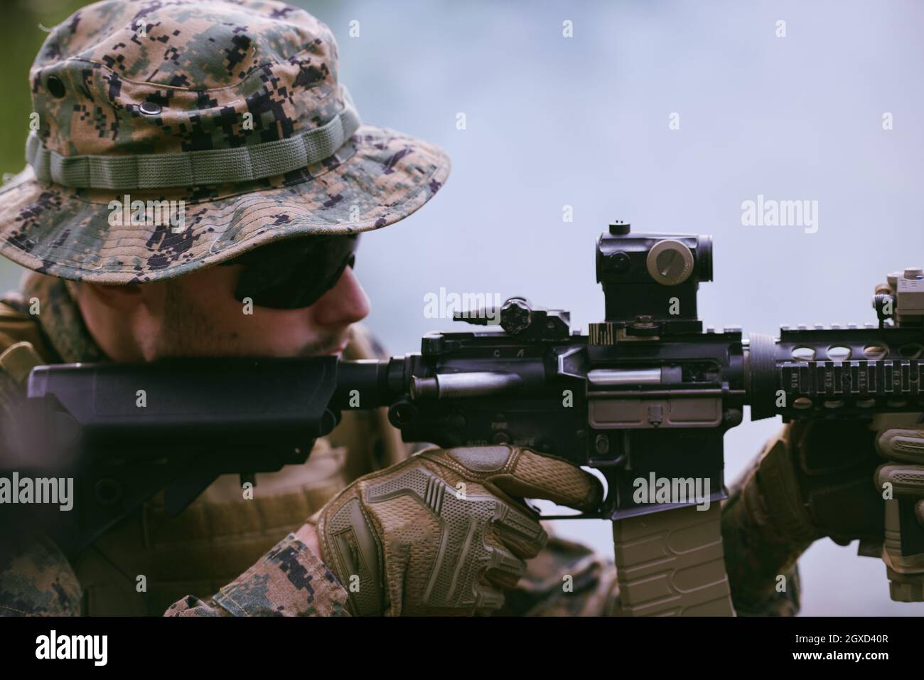 modern warfare soldier in action aiming at weapon laser sight optics in ...