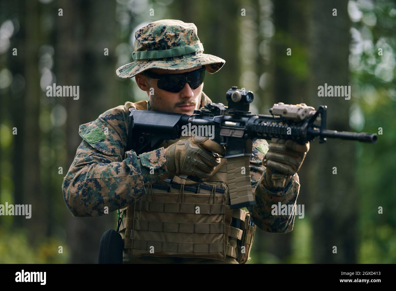 modern warfare soldier in action aiming at weapon laser sight optics in ...