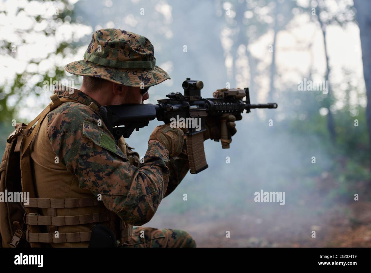 modern warfare soldier in action aiming at weapon laser sight optics in ...