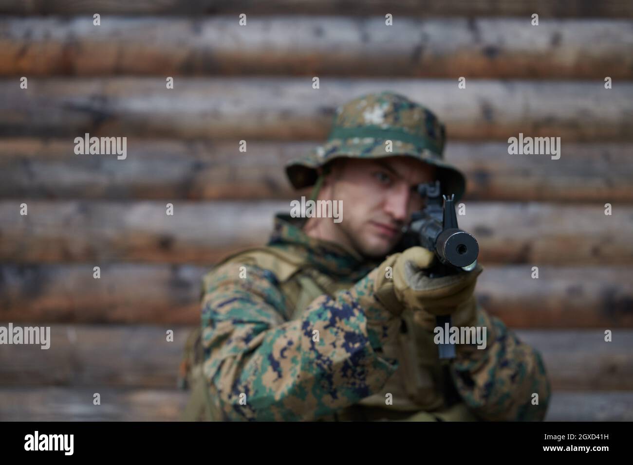 modern warfare soldier in action aiming at weapon laser sight optics in ...