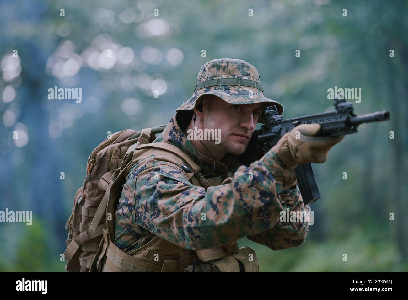 modern warfare soldier in action aiming at weapon laser sight optics in ...