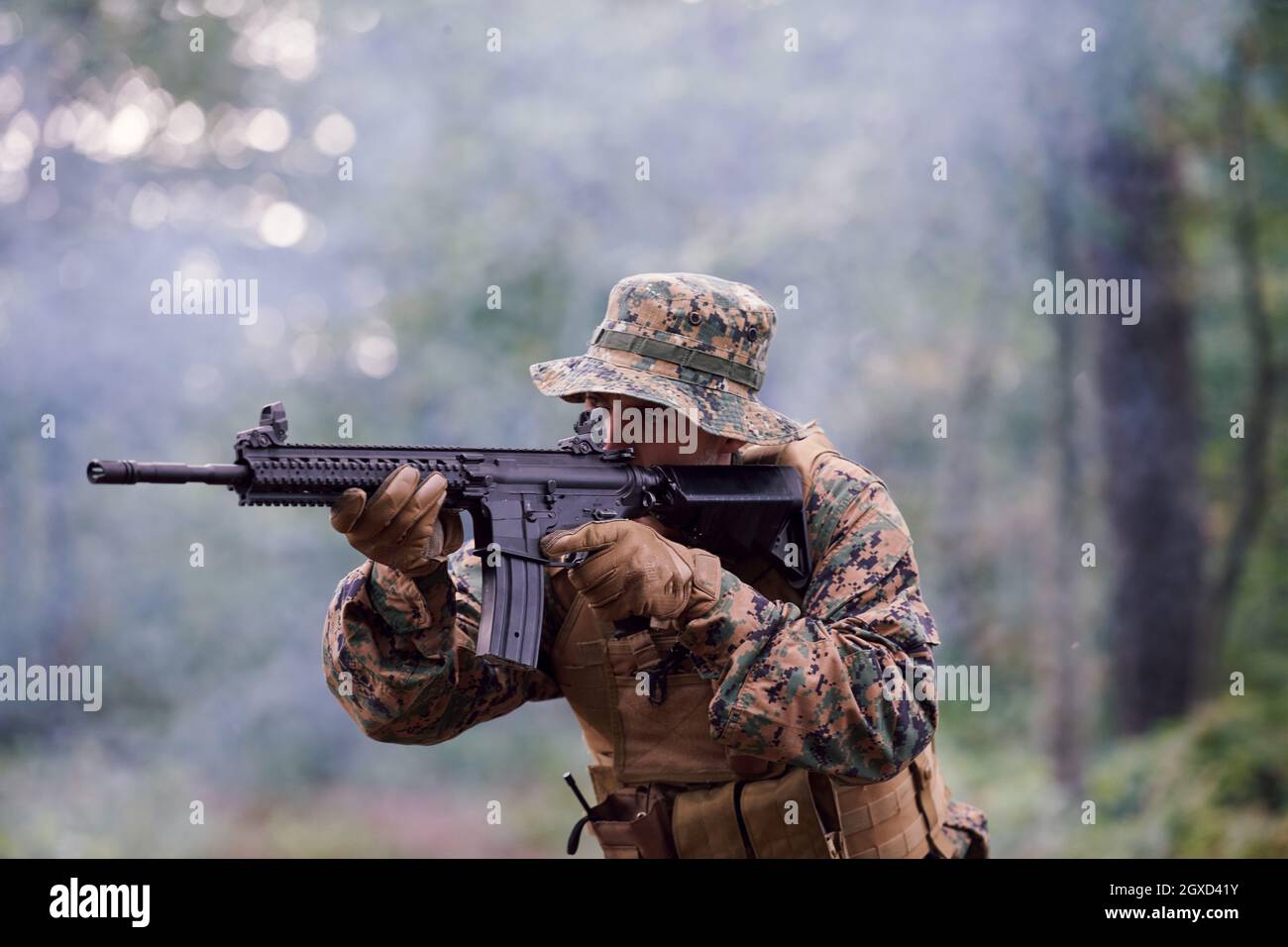 modern warfare soldier in action aiming at weapon laser sight optics in ...