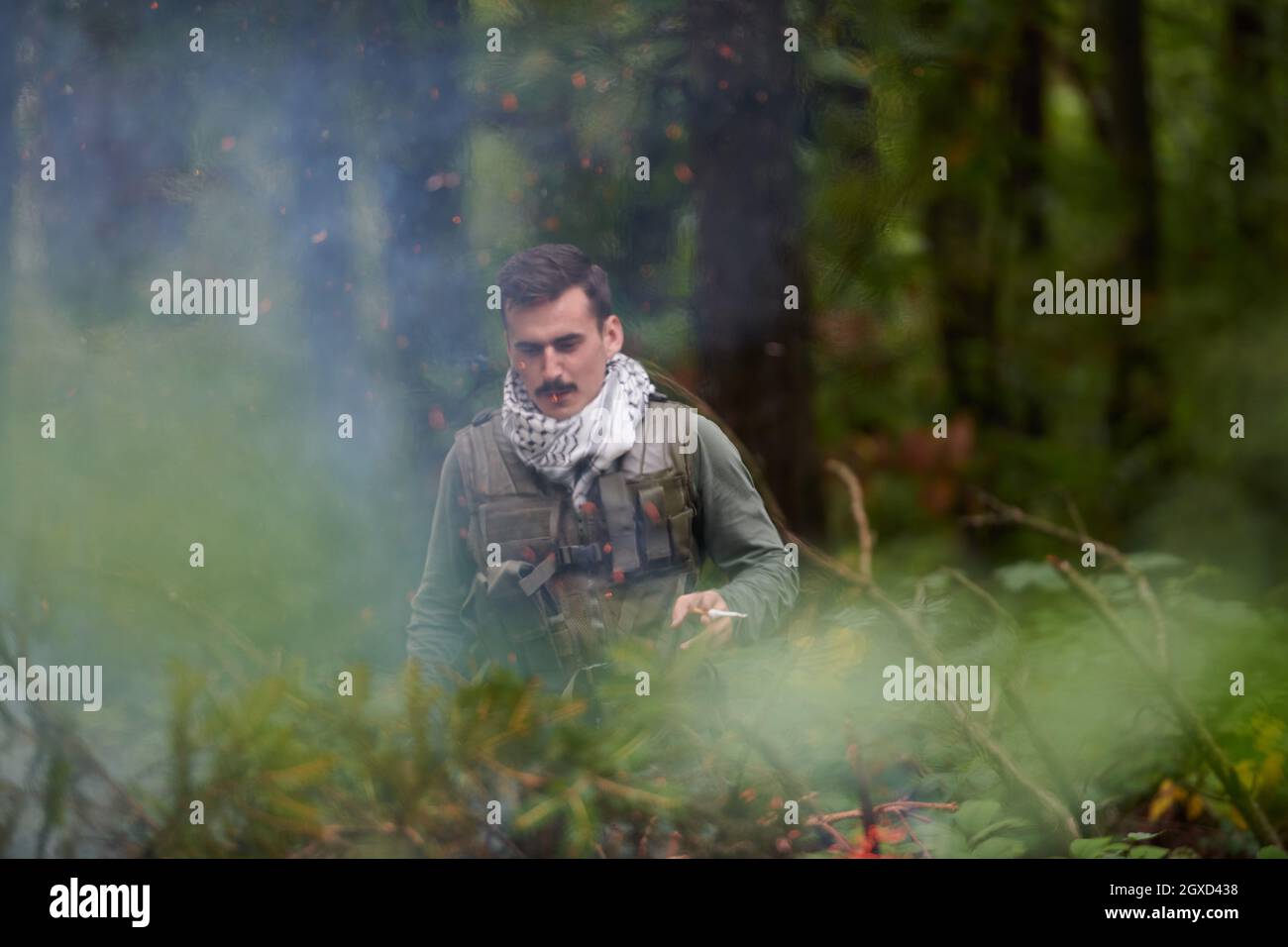 terrorist have a break and smoke cigarette in forest during battle ...