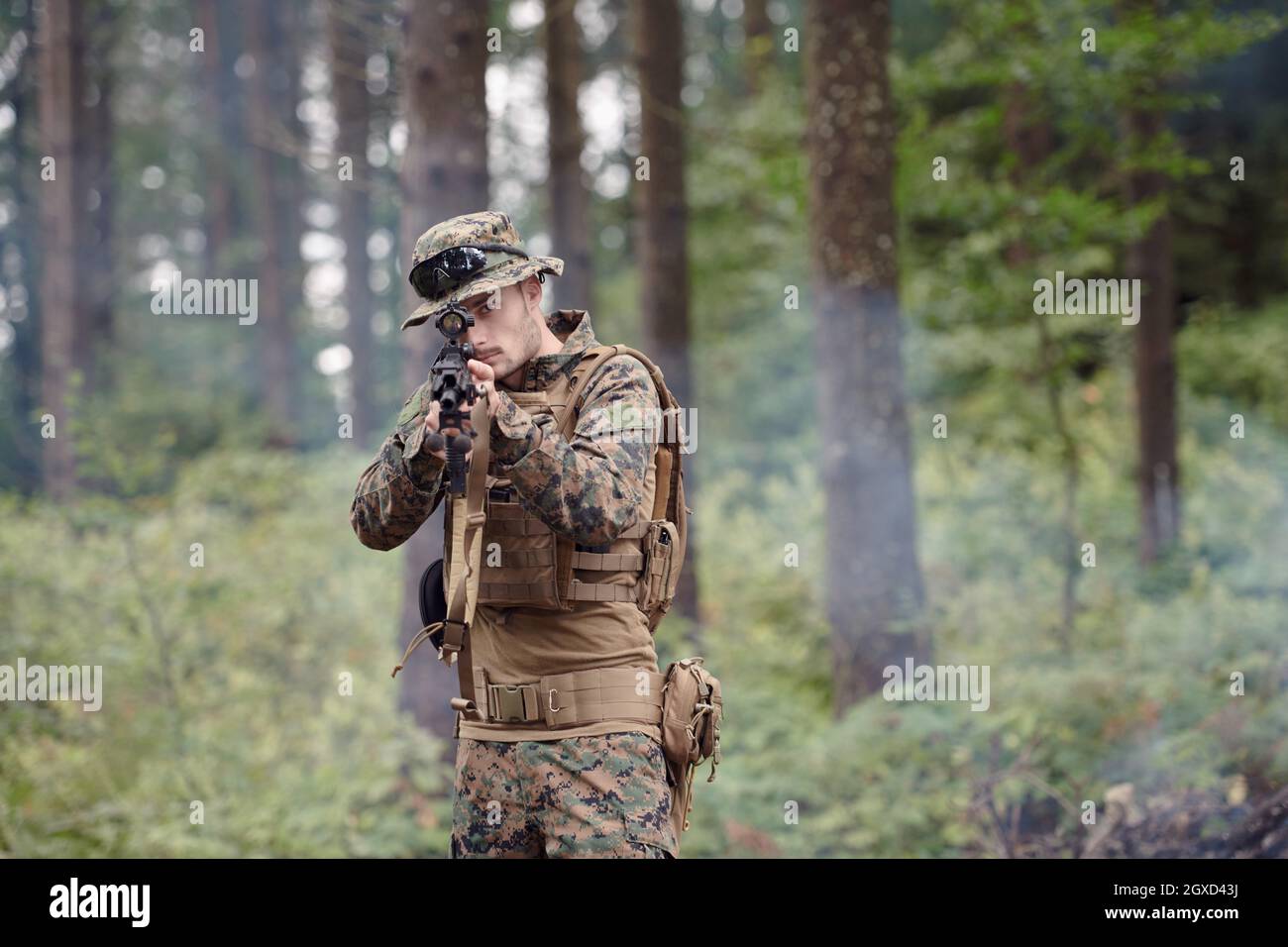 modern warfare soldier in action aiming at weapon laser sight optics in ...