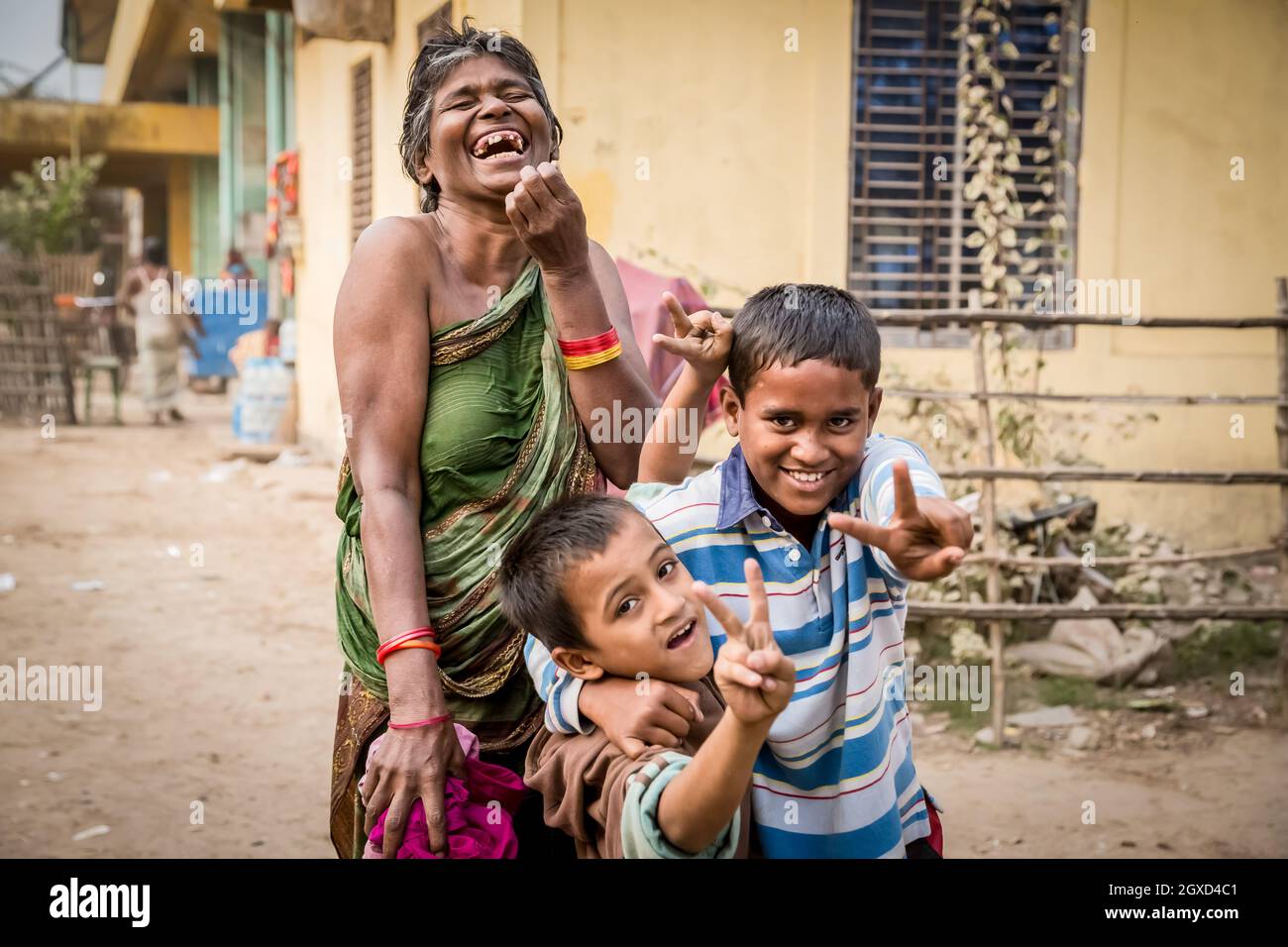 Childhood looking at camera smiling poverty hi-res stock photography ...