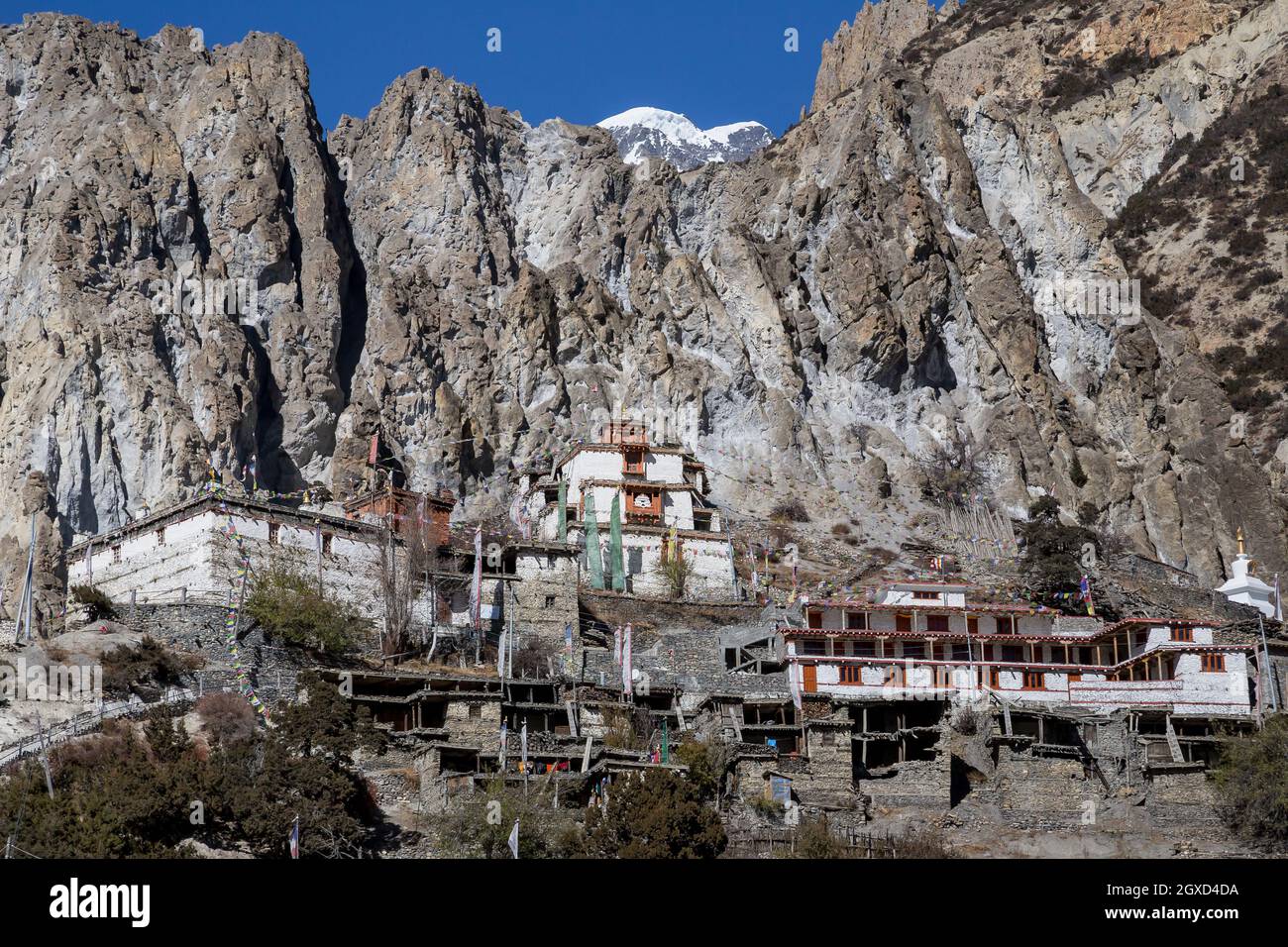 Shabby stone houses of manang town located among high steep rocky ...