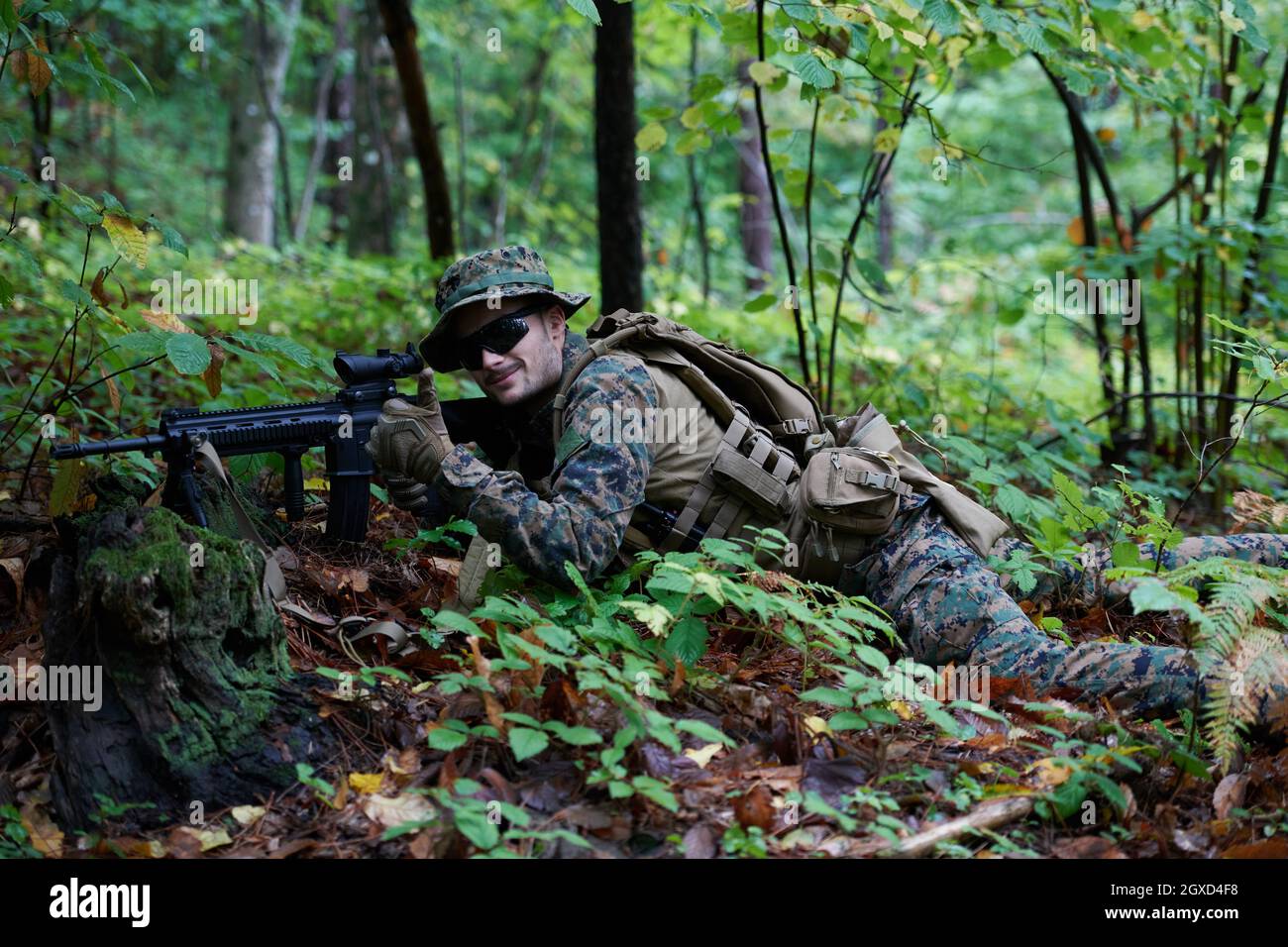 modern warfare soldier in action aiming at weapon laser sight optics in ...
