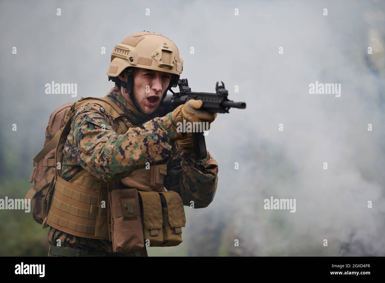 modern warfare soldier in action aiming at weapon laser sight optics in ...