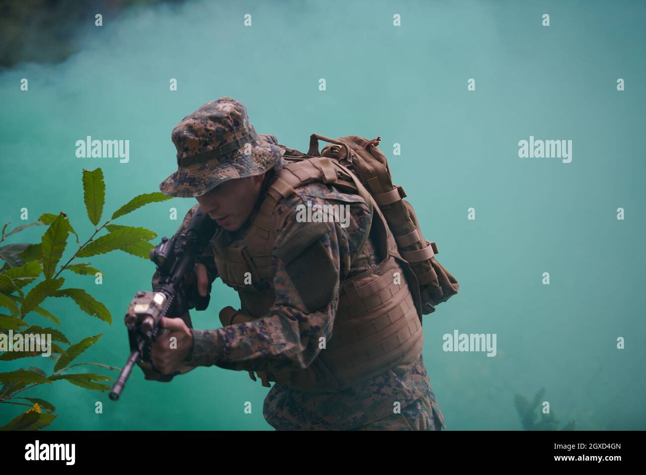 modern warfare soldier in action aiming at weapon laser sight optics in ...