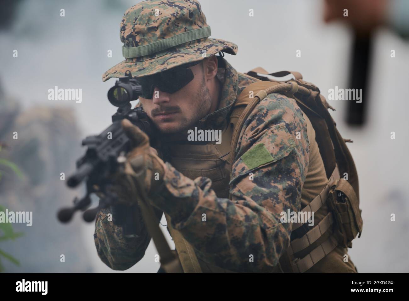 modern warfare soldier in action aiming at weapon laser sight optics in ...