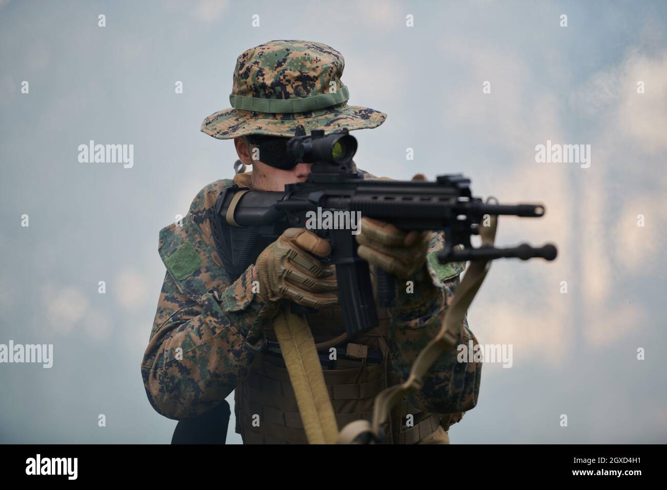 modern warfare soldier in action aiming at weapon laser sight optics in ...