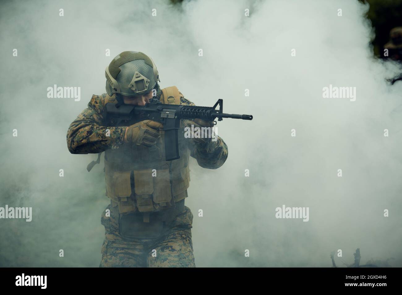 modern warfare soldier in action aiming at weapon laser sight optics in ...