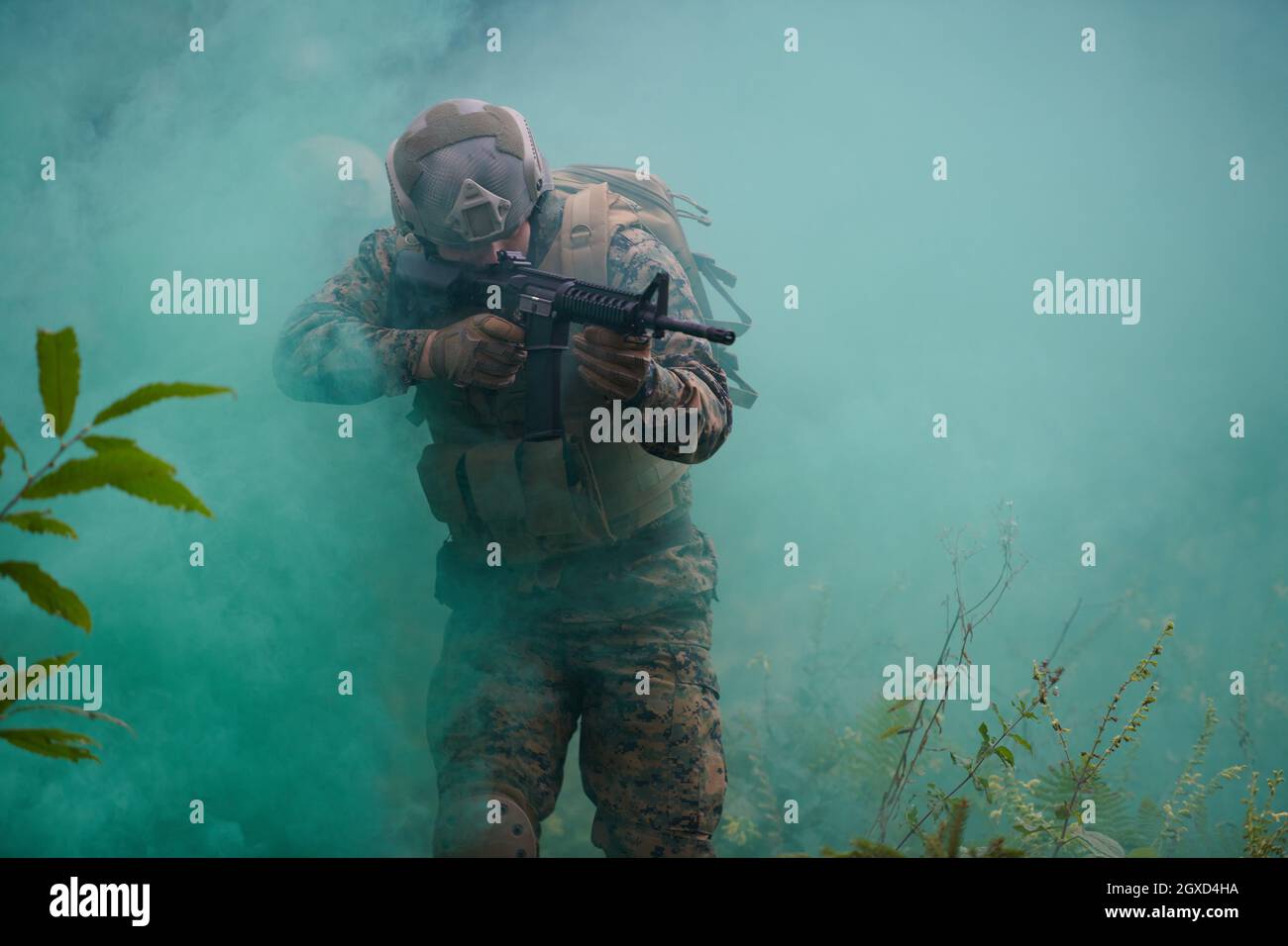 modern warfare soldier in action aiming at weapon laser sight optics in ...