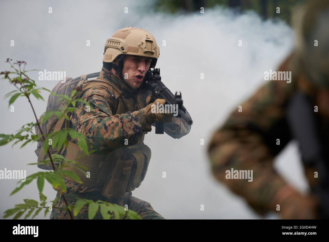 modern warfare soldier in action aiming at weapon laser sight optics in ...