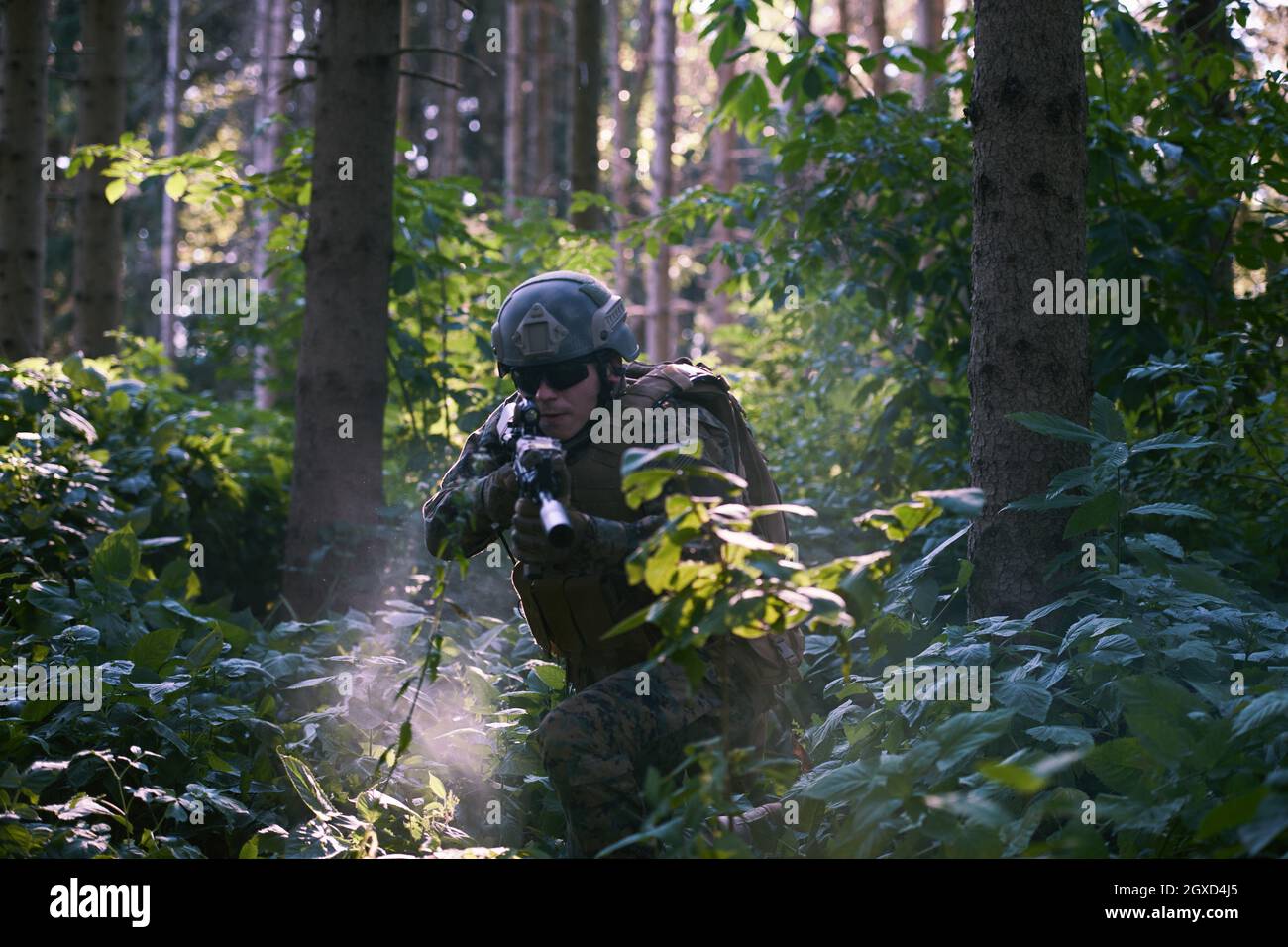 modern warfare soldier in action aiming at weapon laser sight optics in ...