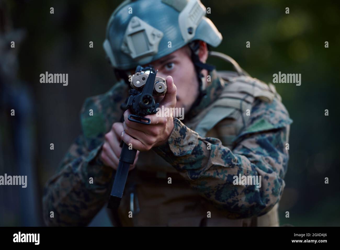 modern warfare soldier in action aiming at weapon laser sight optics in ...