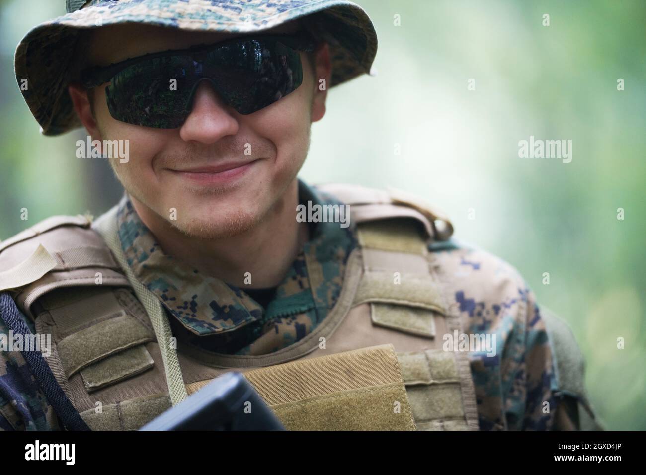 soldier portrait with protective army tactical gear and weapon having a ...