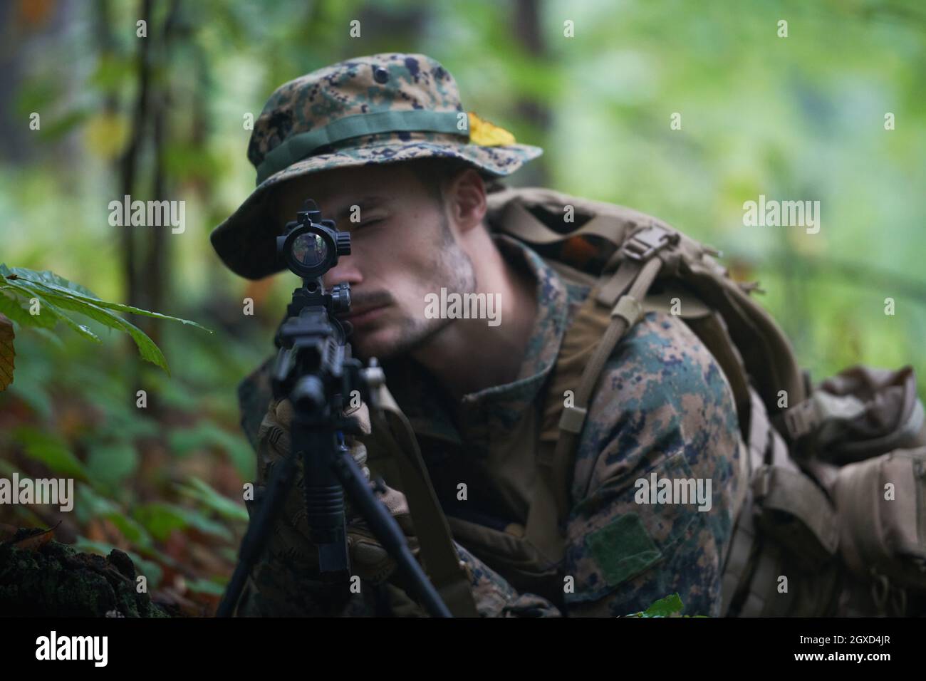 modern warfare soldier in action aiming at weapon laser sight optics in ...