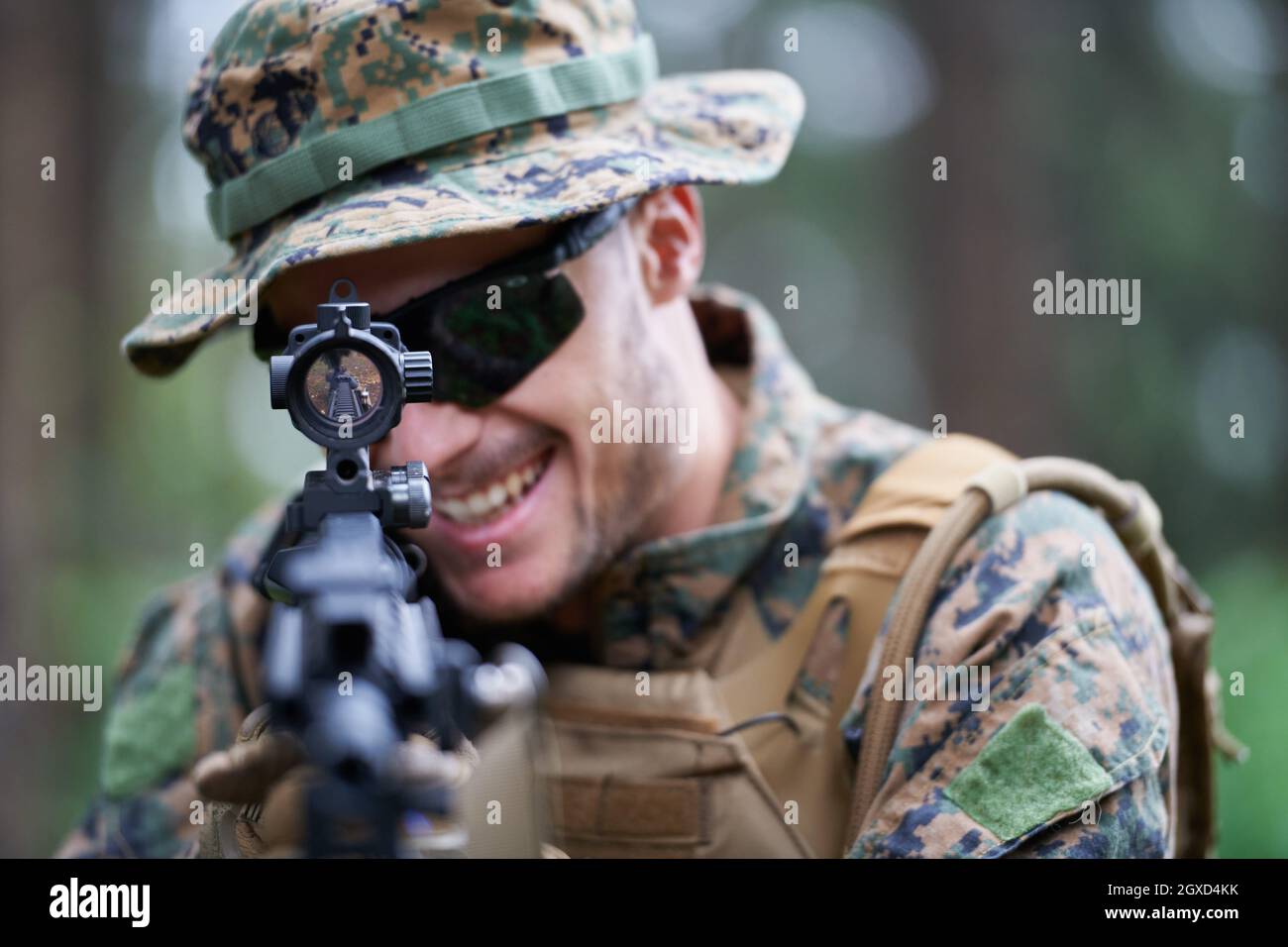 modern warfare soldier in action aiming at weapon laser sight optics in ...