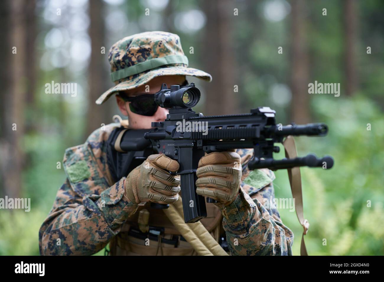 modern warfare soldier in action aiming at weapon laser sight optics in ...