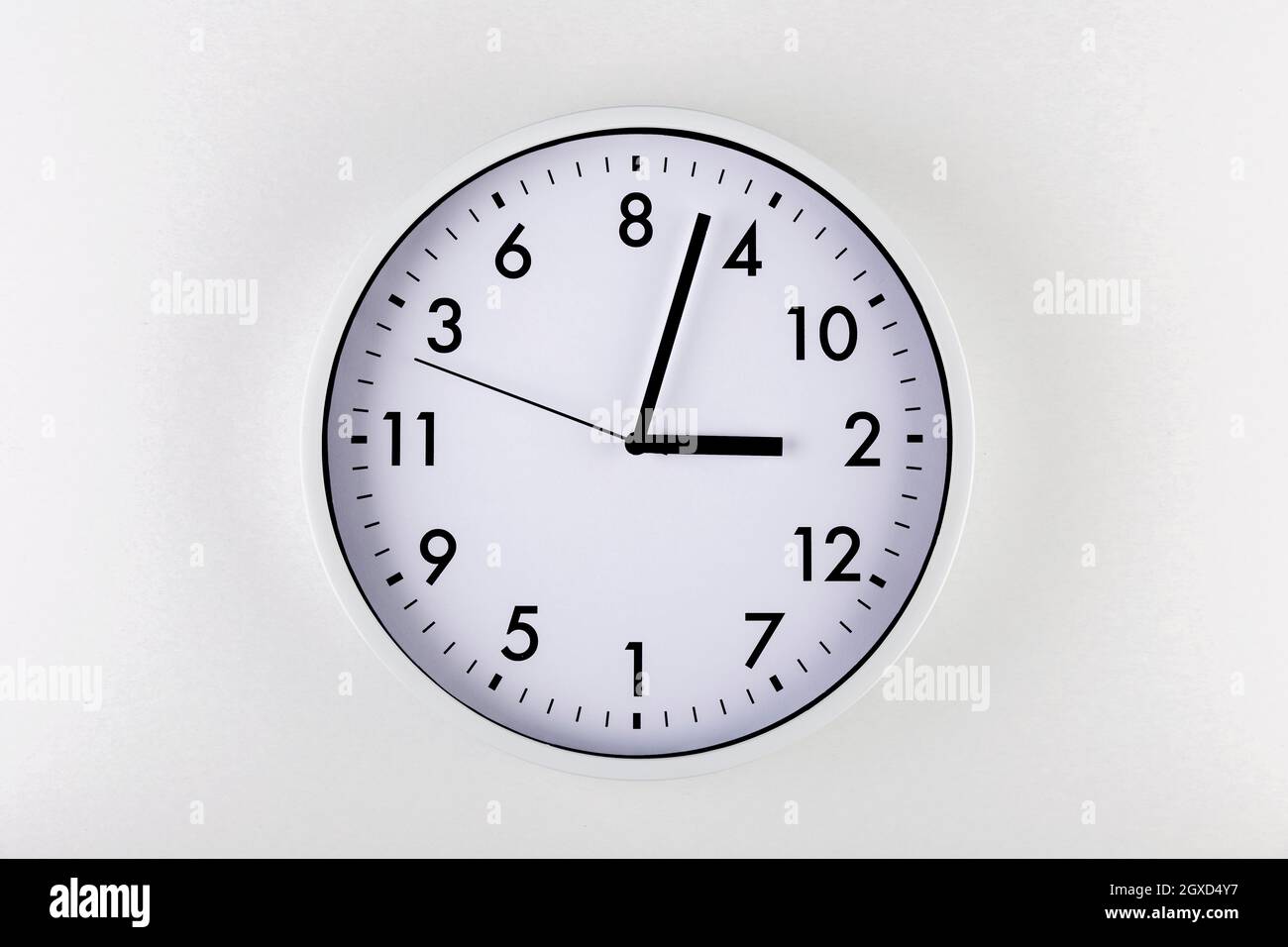 Round shaped minimalistic clock with arrows on white background Stock ...