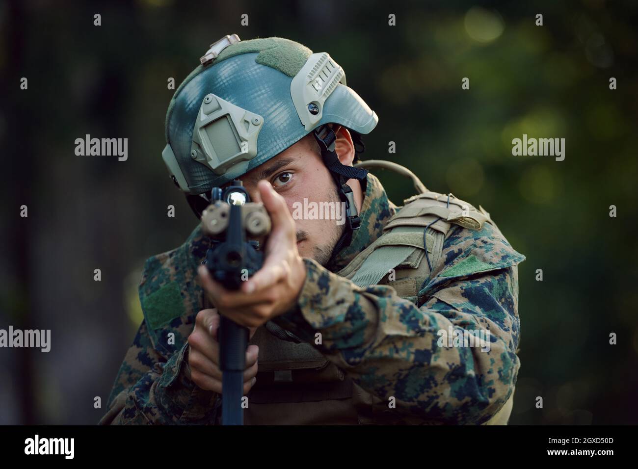 modern warfare soldier in action aiming at weapon laser sight optics in ...