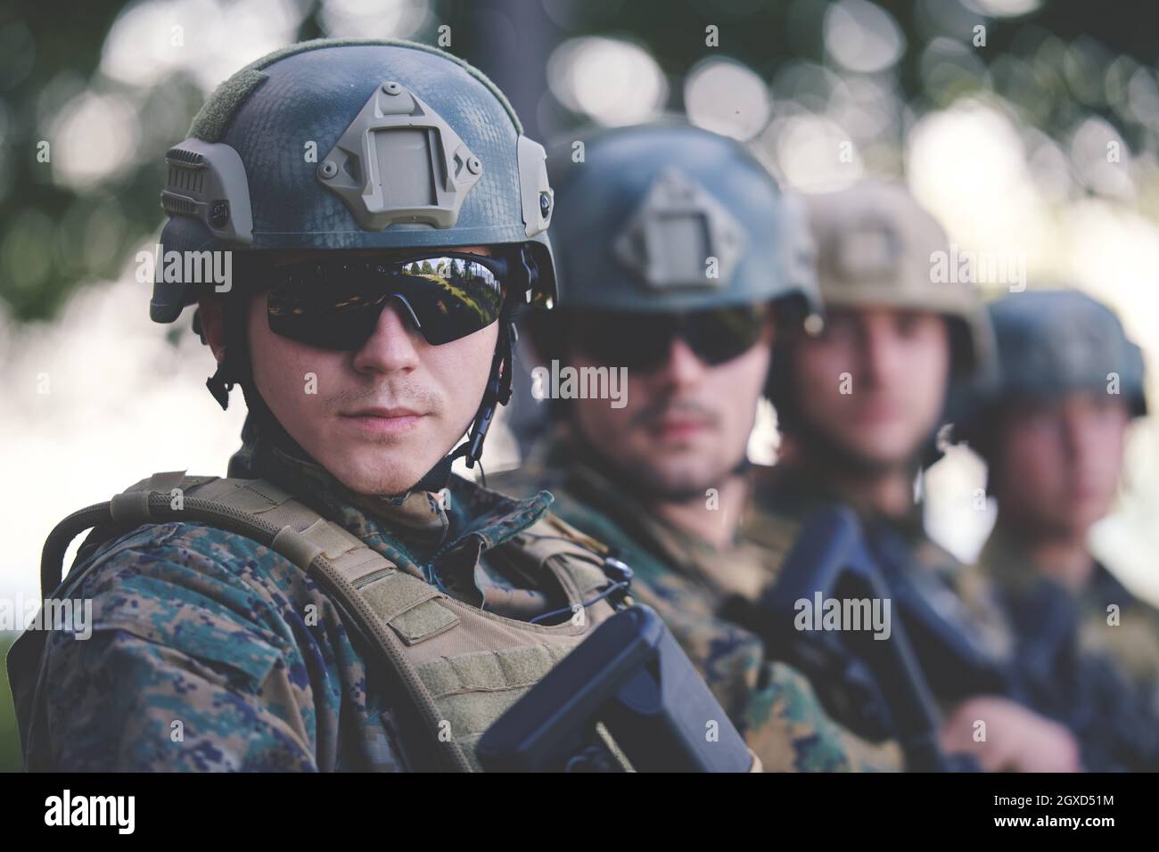Soldier fighters standing together with guns. Group portrait of US army ...