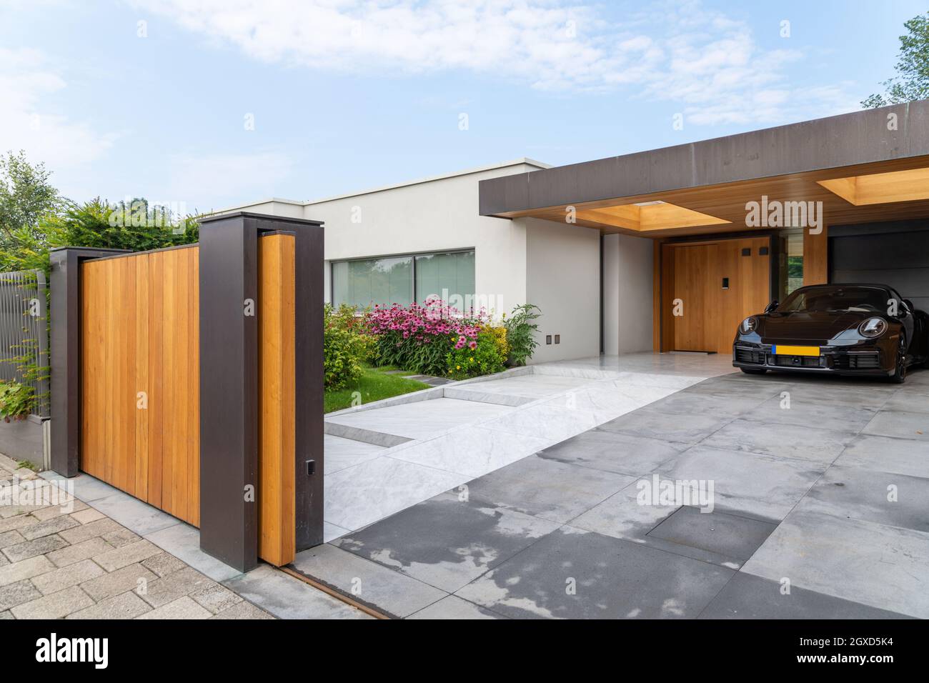 Modern sport car parked in backyard of stylish minimalist villa ...