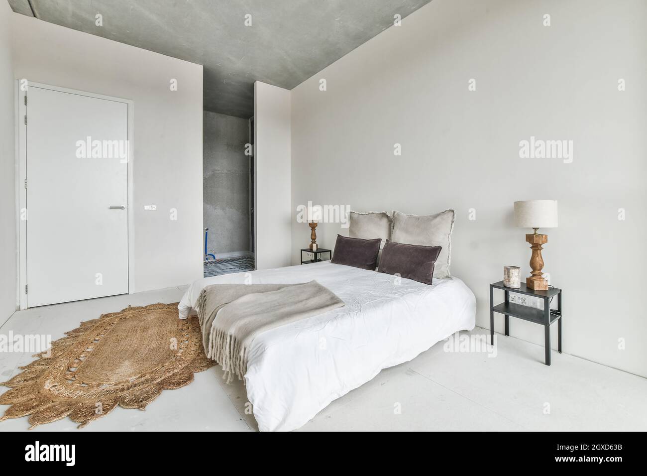 Creative design of bedroom with cushions and cover on bed between door ...