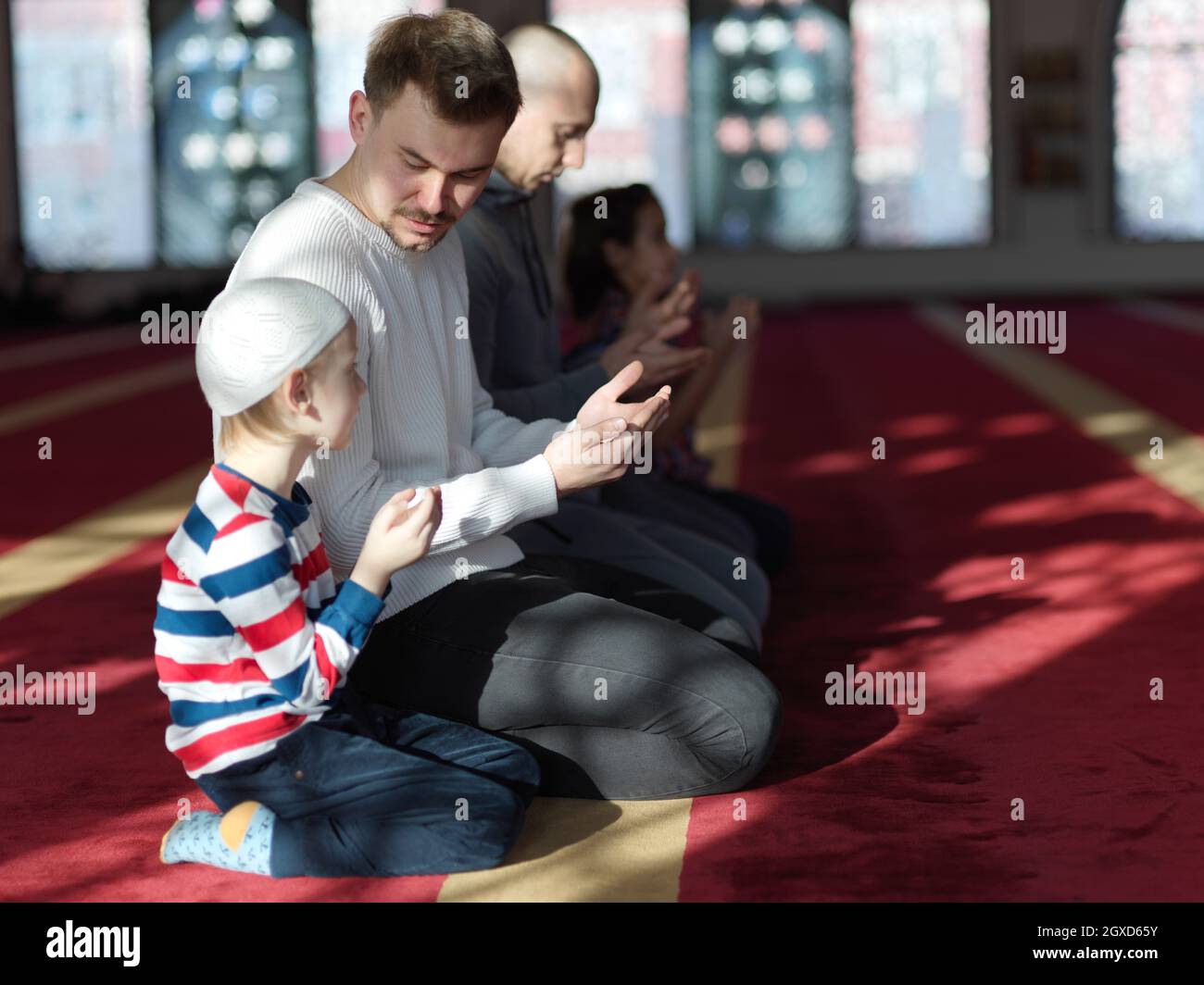 muslim prayer father and son in mosque praying Allah Stock Photo - Alamy